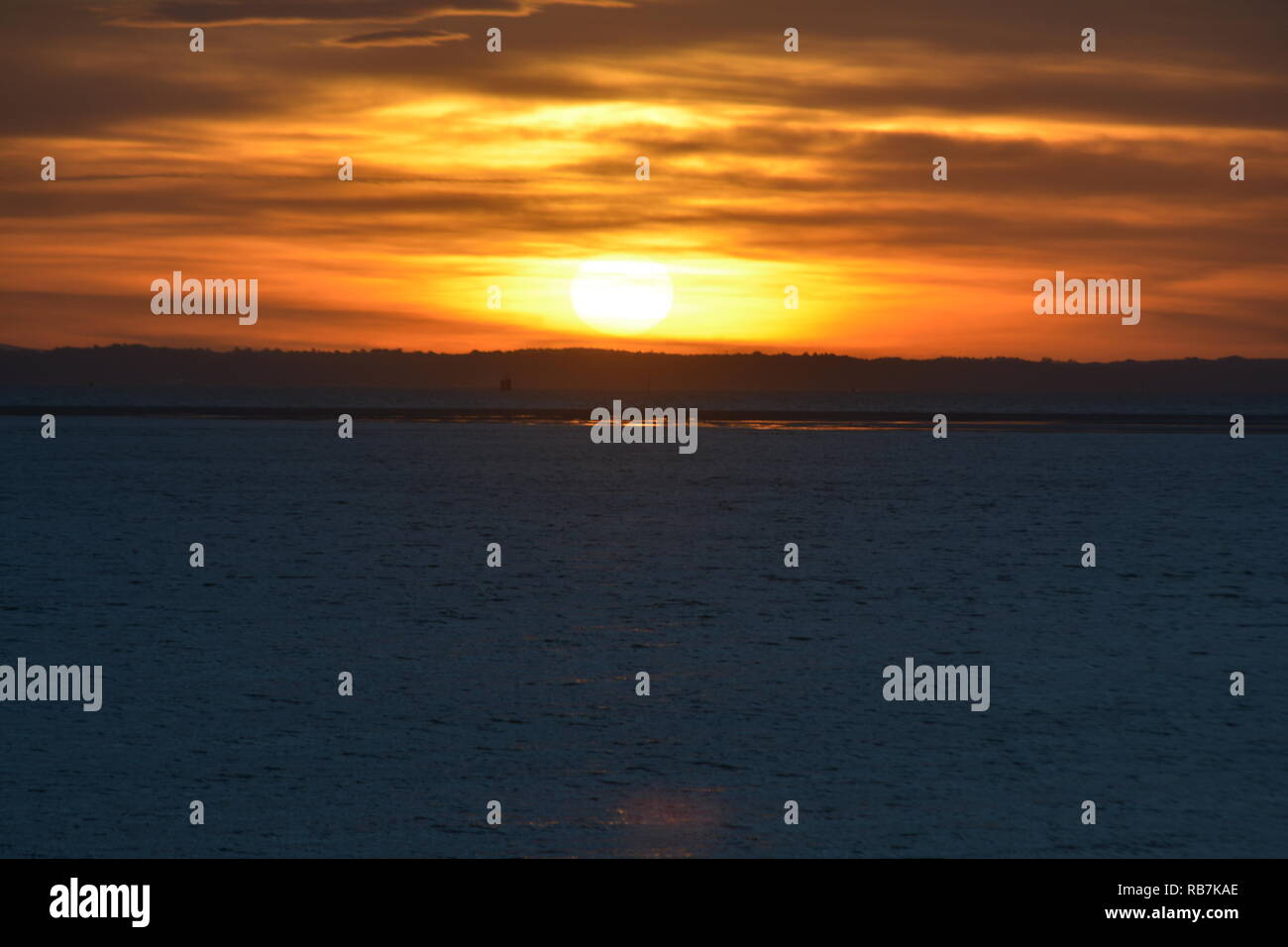 sunset over the isle of wight, with lots of yellow and orange in the ...