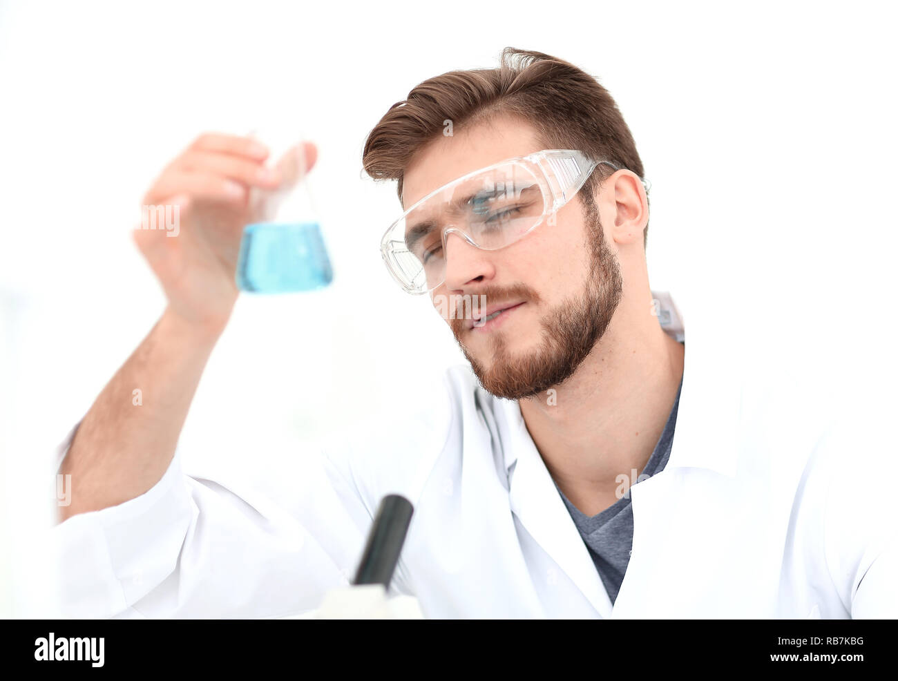 closeup. chemist holding a beaker with a solution Stock Photo - Alamy