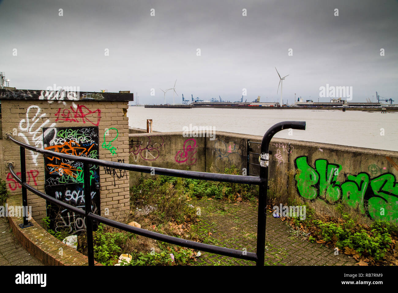 Graffiti on the flood defences next to the Thames at Gravesend in Kent ...