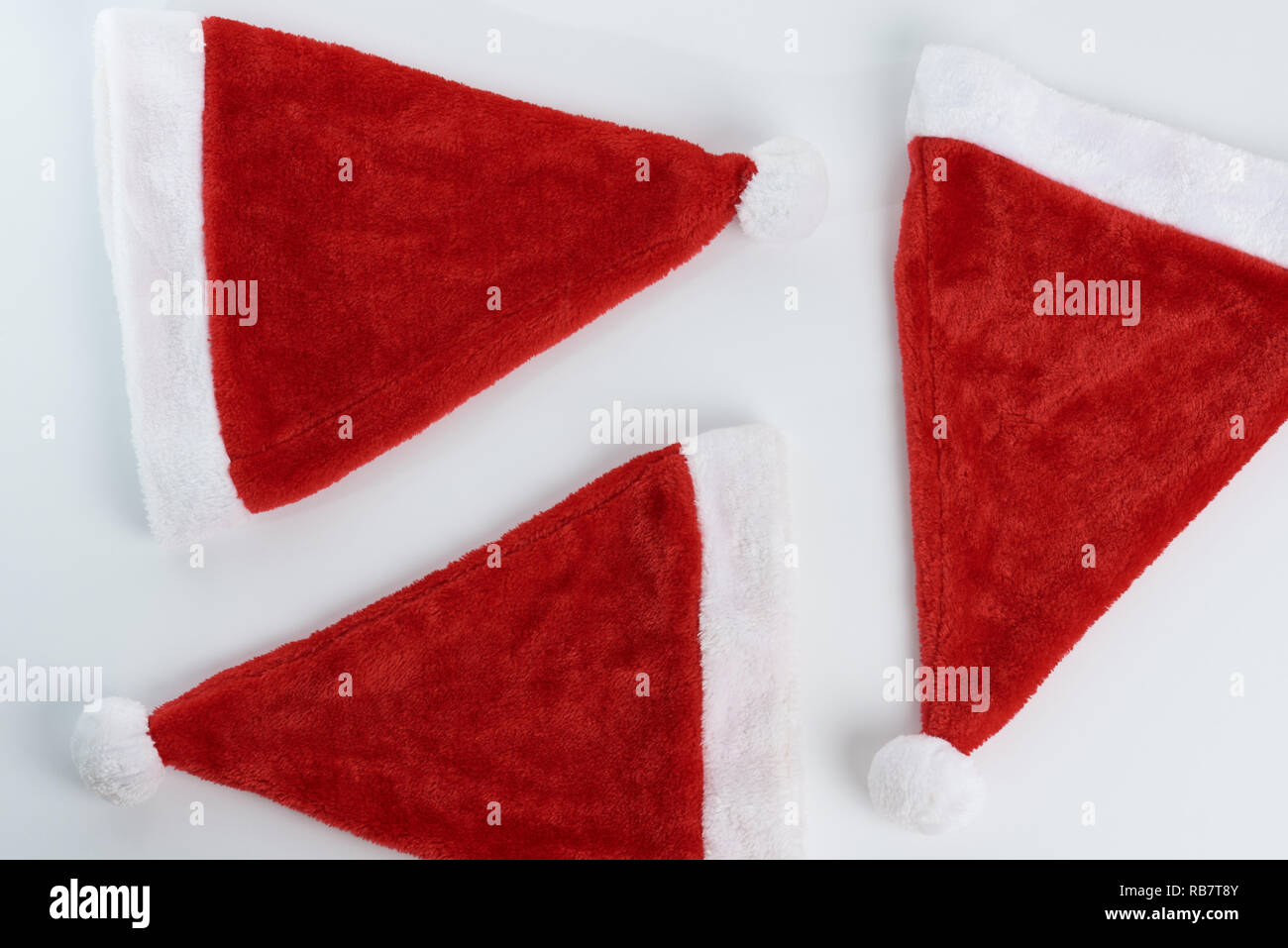 Group of santa clause hats above top view on white background Stock ...