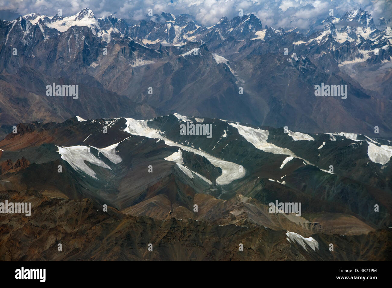 High mountain ranges with white spots glaciers on the tops of the ridge ...