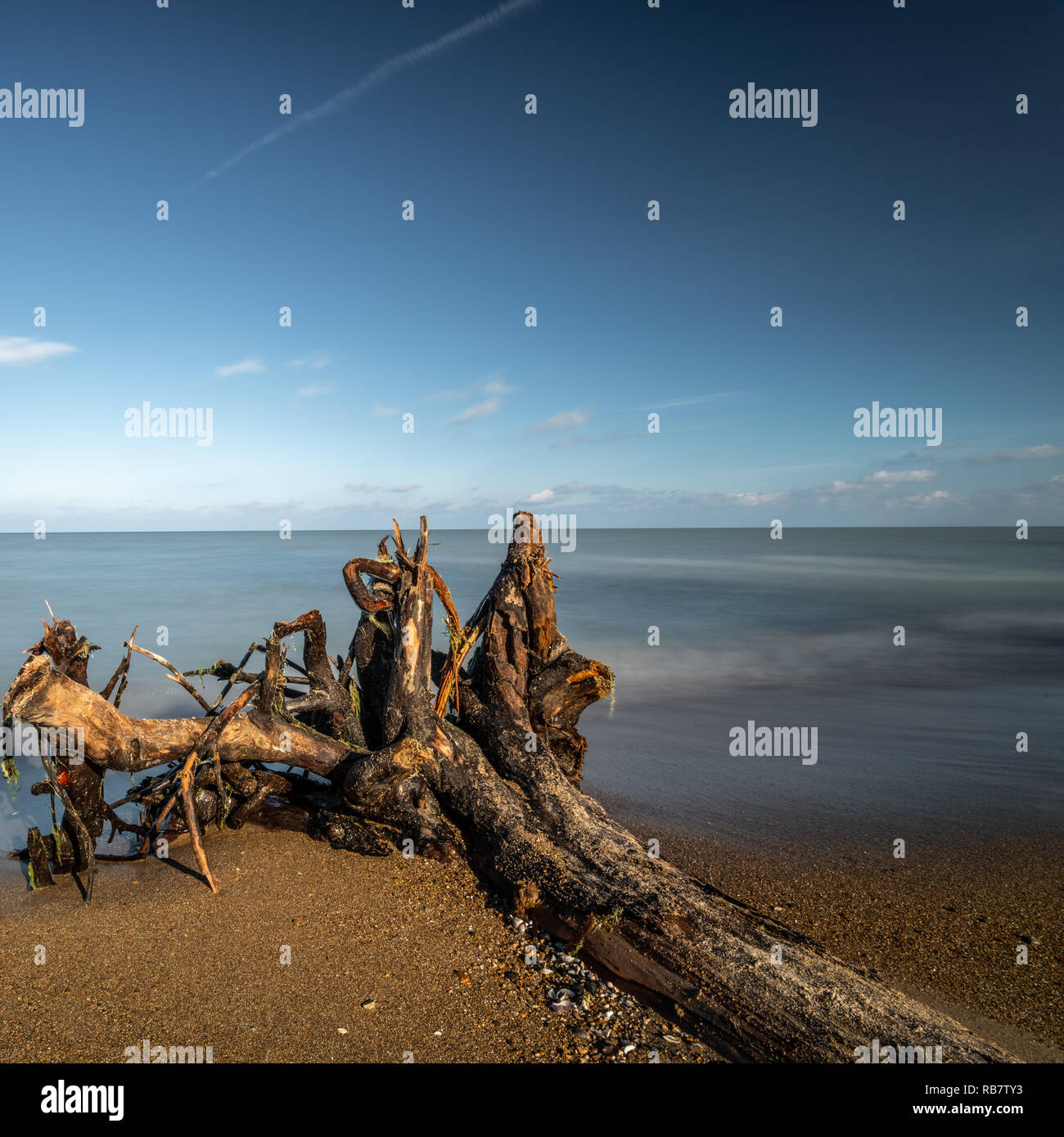 Long exposure at the beach, cloudy sky Stock Photo - Alamy