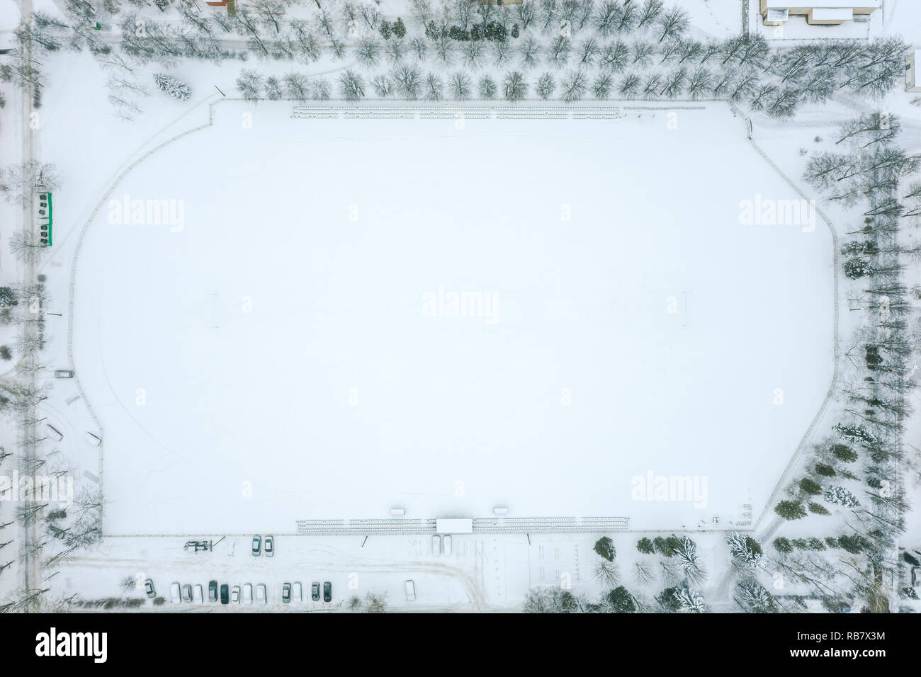 aerial top view of football field covered with snow. school stadium in ...
