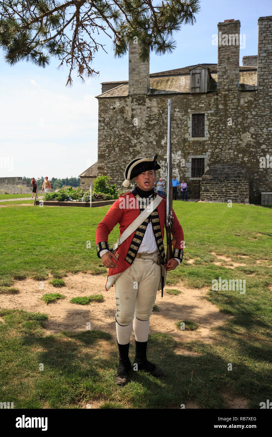 18'th century British soldier reenactor demonstrating the loading and ...