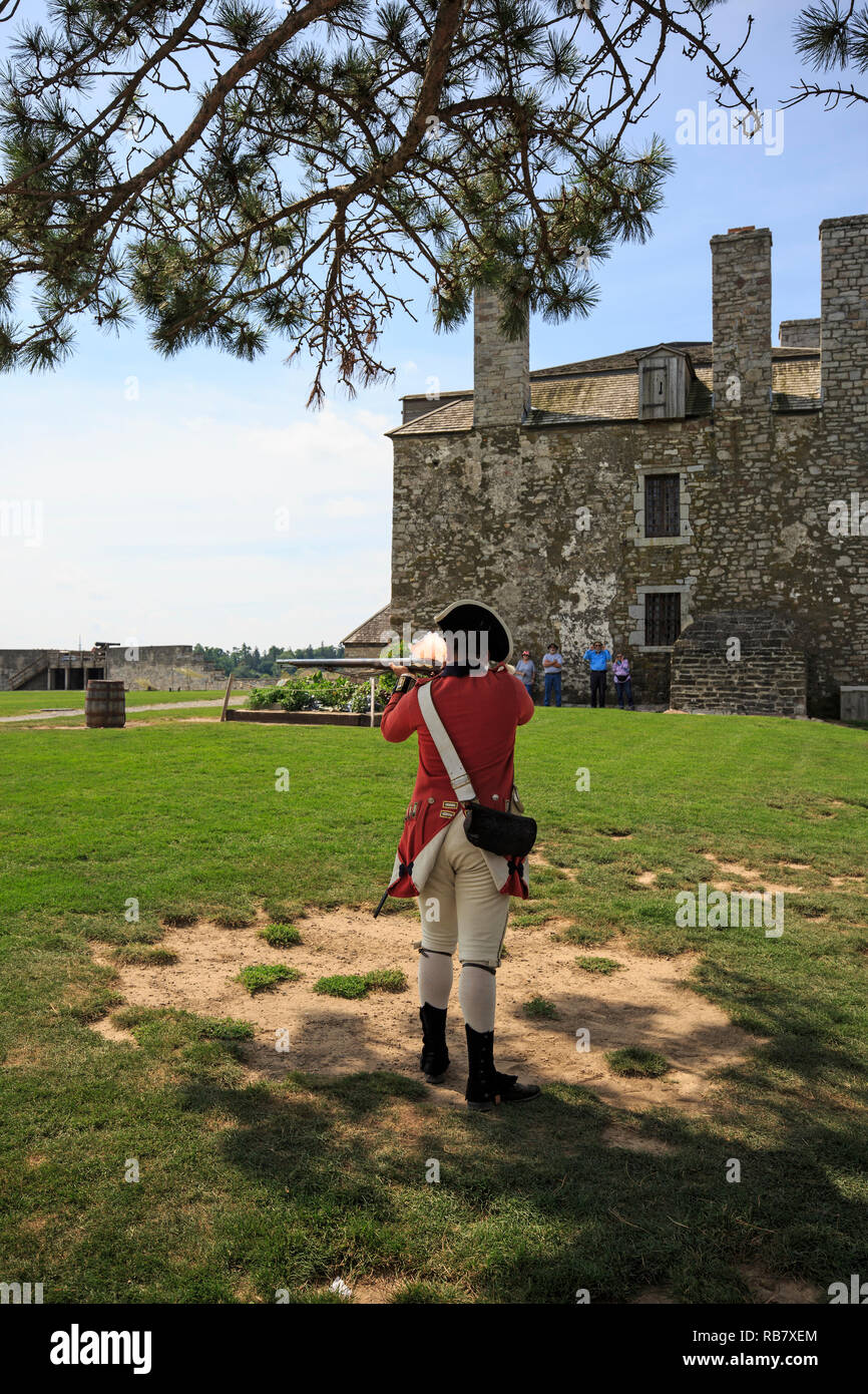 18'th century British soldier reenactor demonstrating the loading and ...