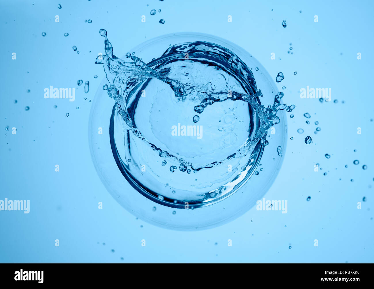 Overhead view of fish bowl and water splash Stock Photo - Alamy