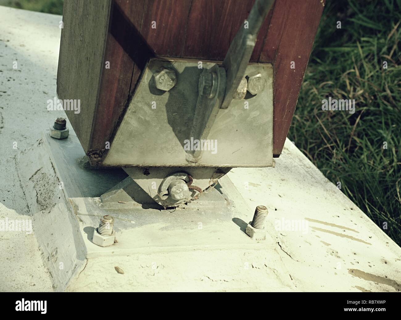 Steel tie joint with swing beam and anchored into concrete. Modern foot ...