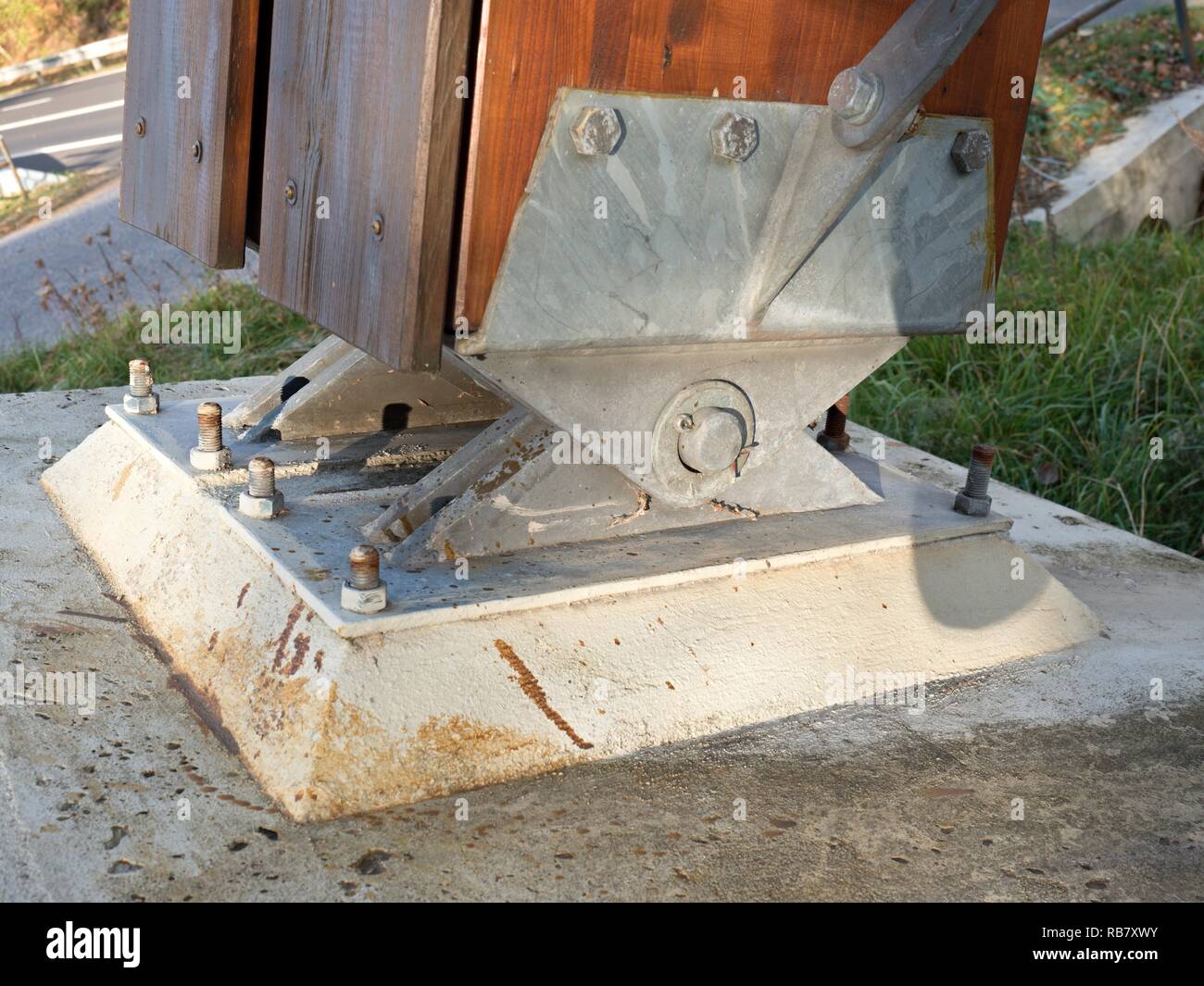 Steel tie joint with swing beam and anchored into concrete. Modern foot ...