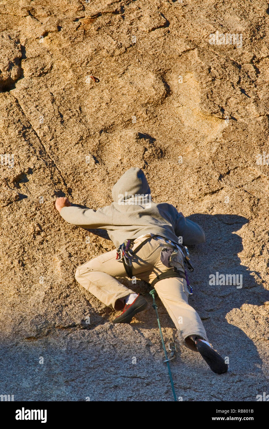Rock climber scaling exposed rock face in Alabama Hills near Lone Pine ...