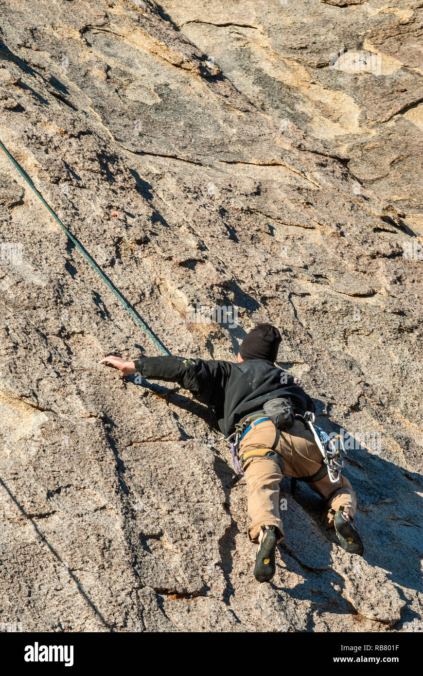 Rock climber scaling exposed rock face in Alabama Hills near Lone Pine ...