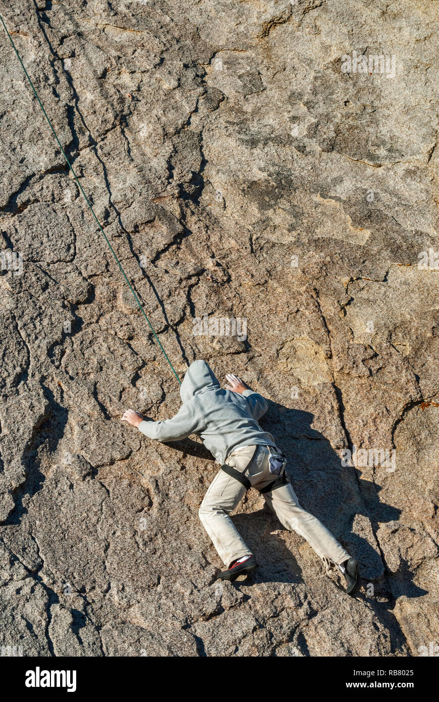 Rock climber scaling exposed rock face in Alabama Hills near Lone Pine ...