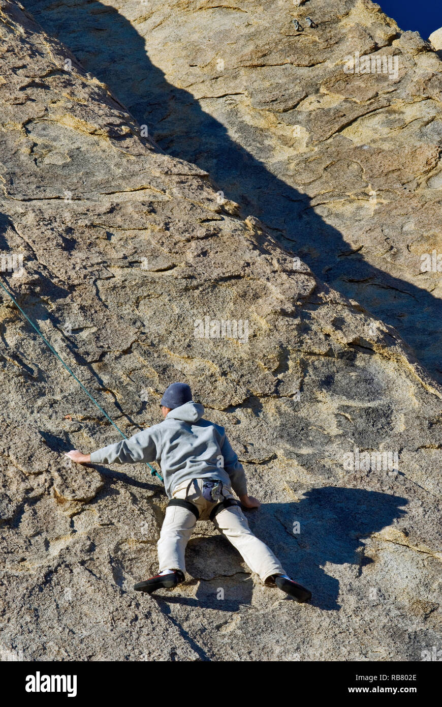 Rock climber scaling exposed rock face in Alabama Hills near Lone Pine ...