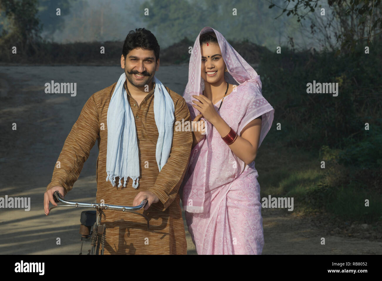 Portrait of a happy rural couple standing on a street in village Stock ...