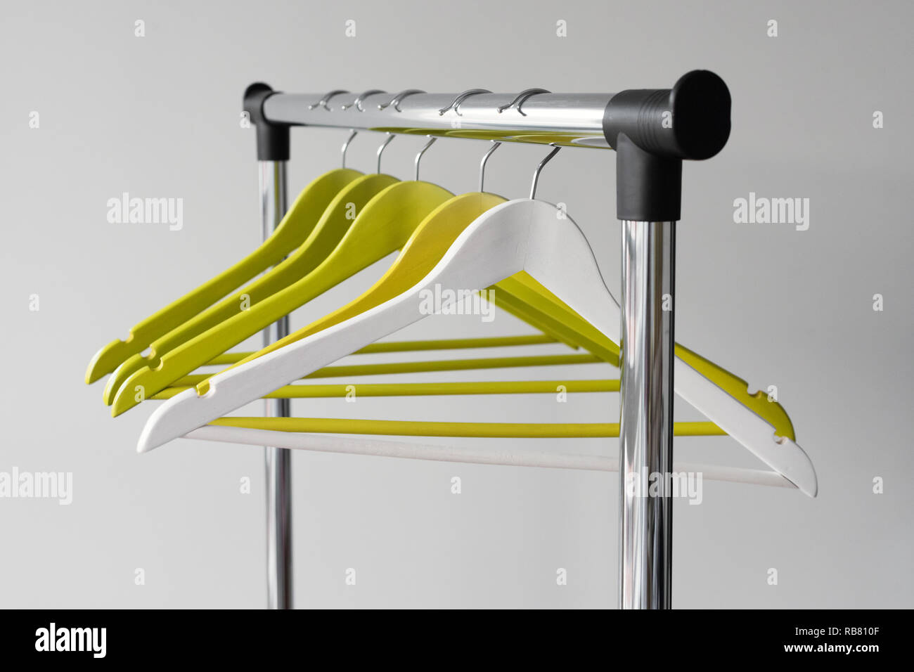 Empty clothes hangers on metal rail against grey background ...