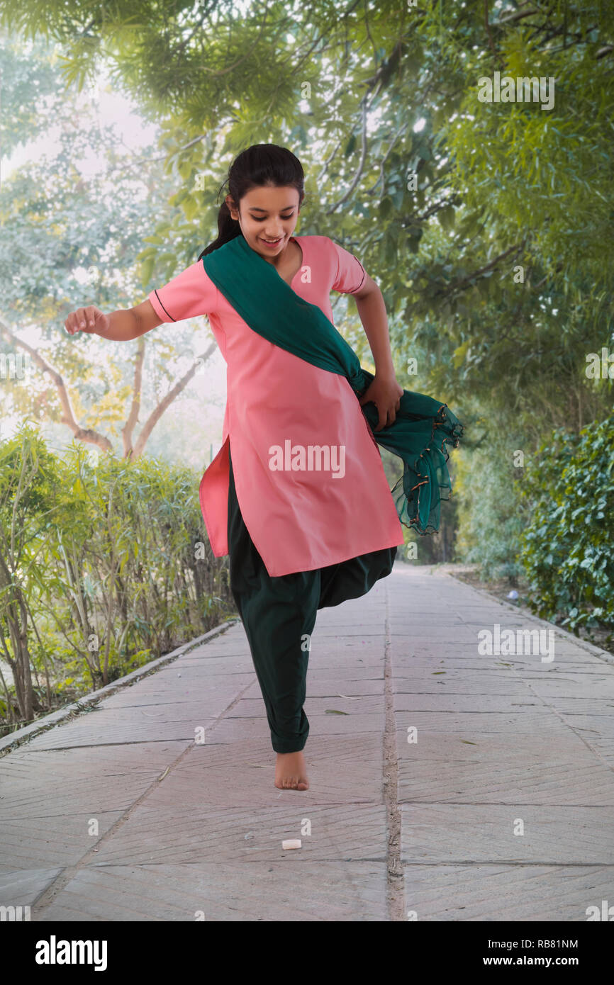 Rural girl playing hopping game in park Stock Photo - Alamy
