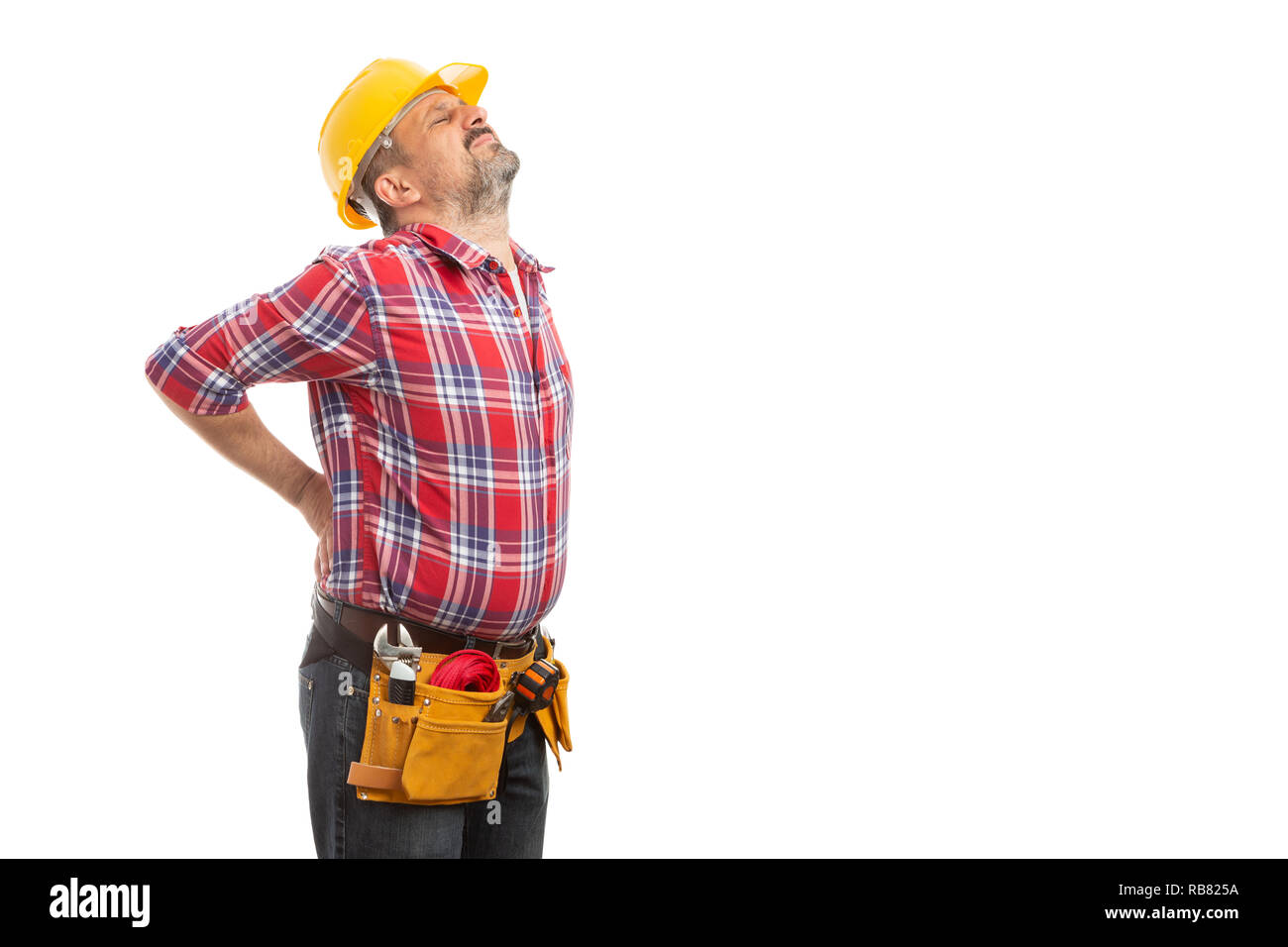 Male builder stretching painful back as hurt because of hard physical ...