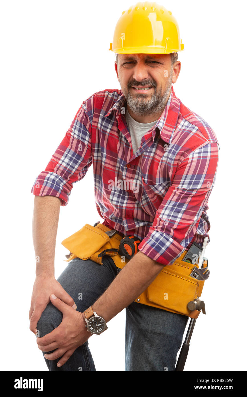 Builder with hands on painful injured knee making concerned expression ...