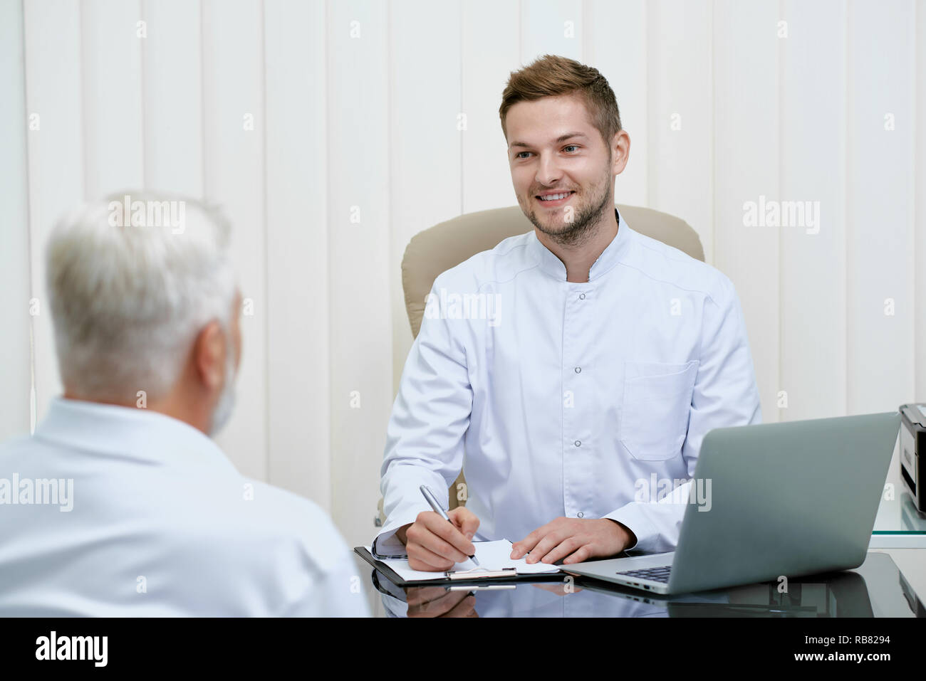 Indoor horizontal portrait of two people talking in hospital. Two ...