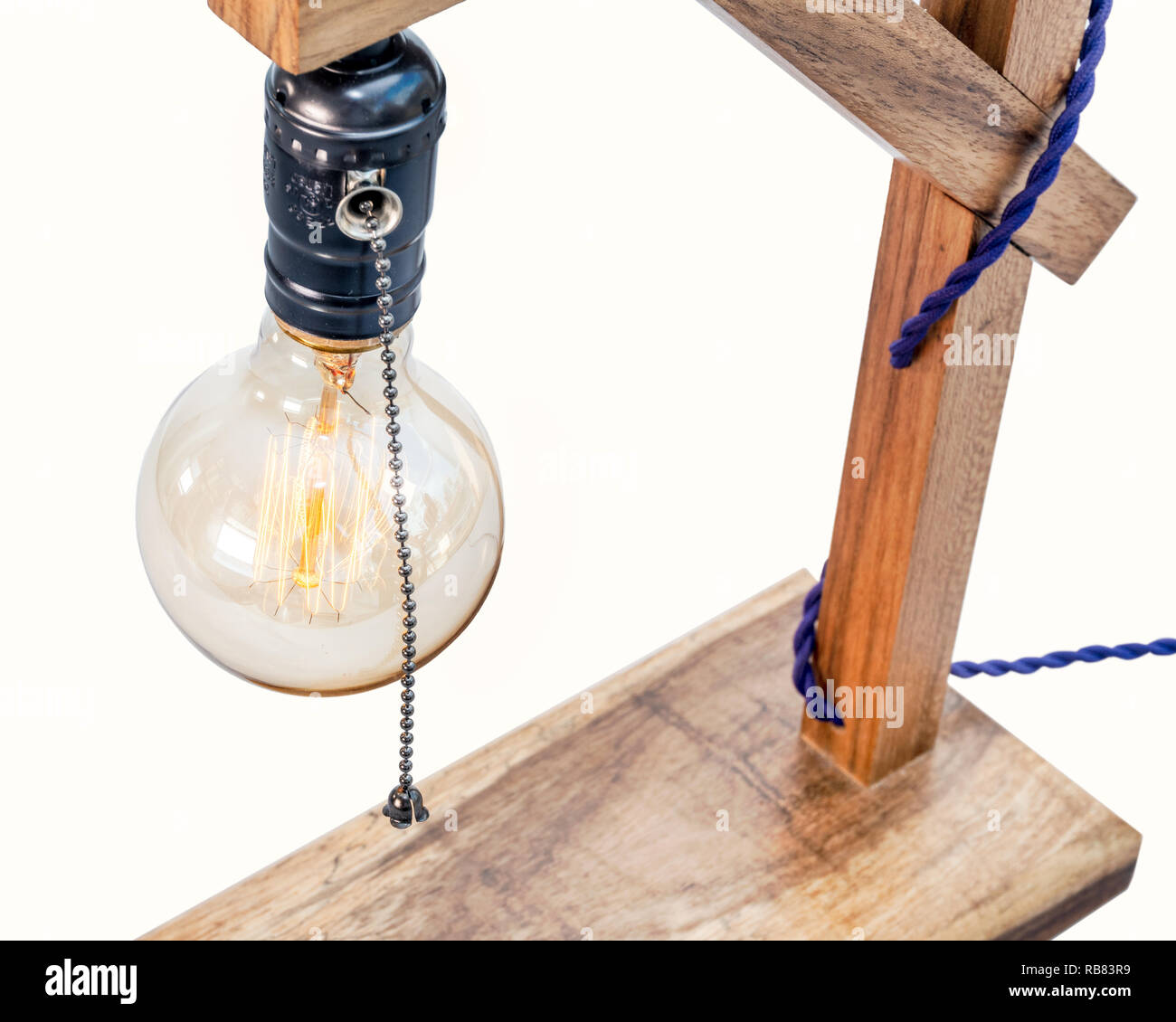 Rustic wood table lamp with small white lampshade isolated on white ...