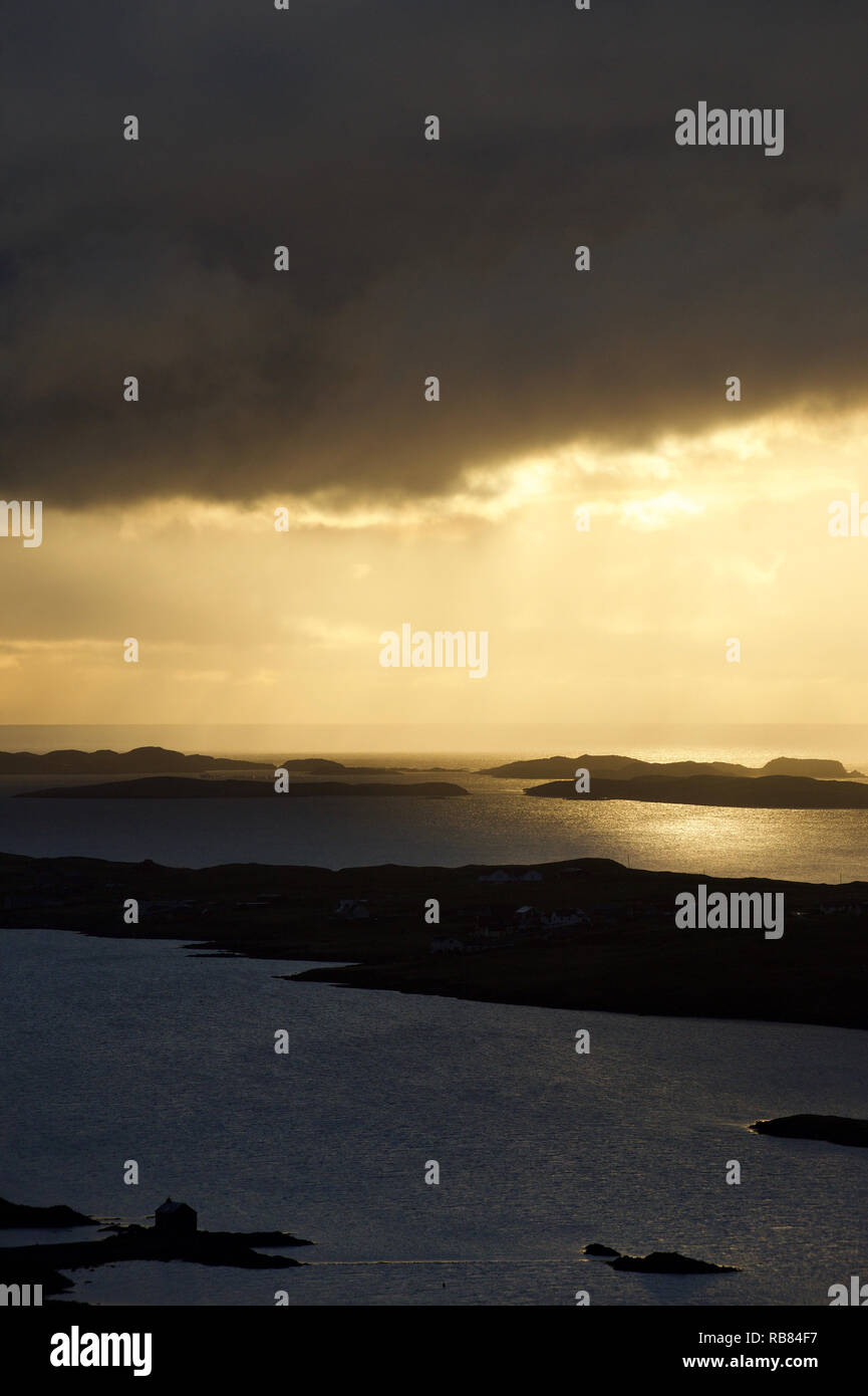 Dark storm clouds roll over a dramatic Shetland landscape—moody skies ...