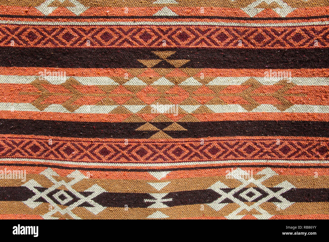 Old traditional Jordan carpet with a geometric pattern in pink and red ...