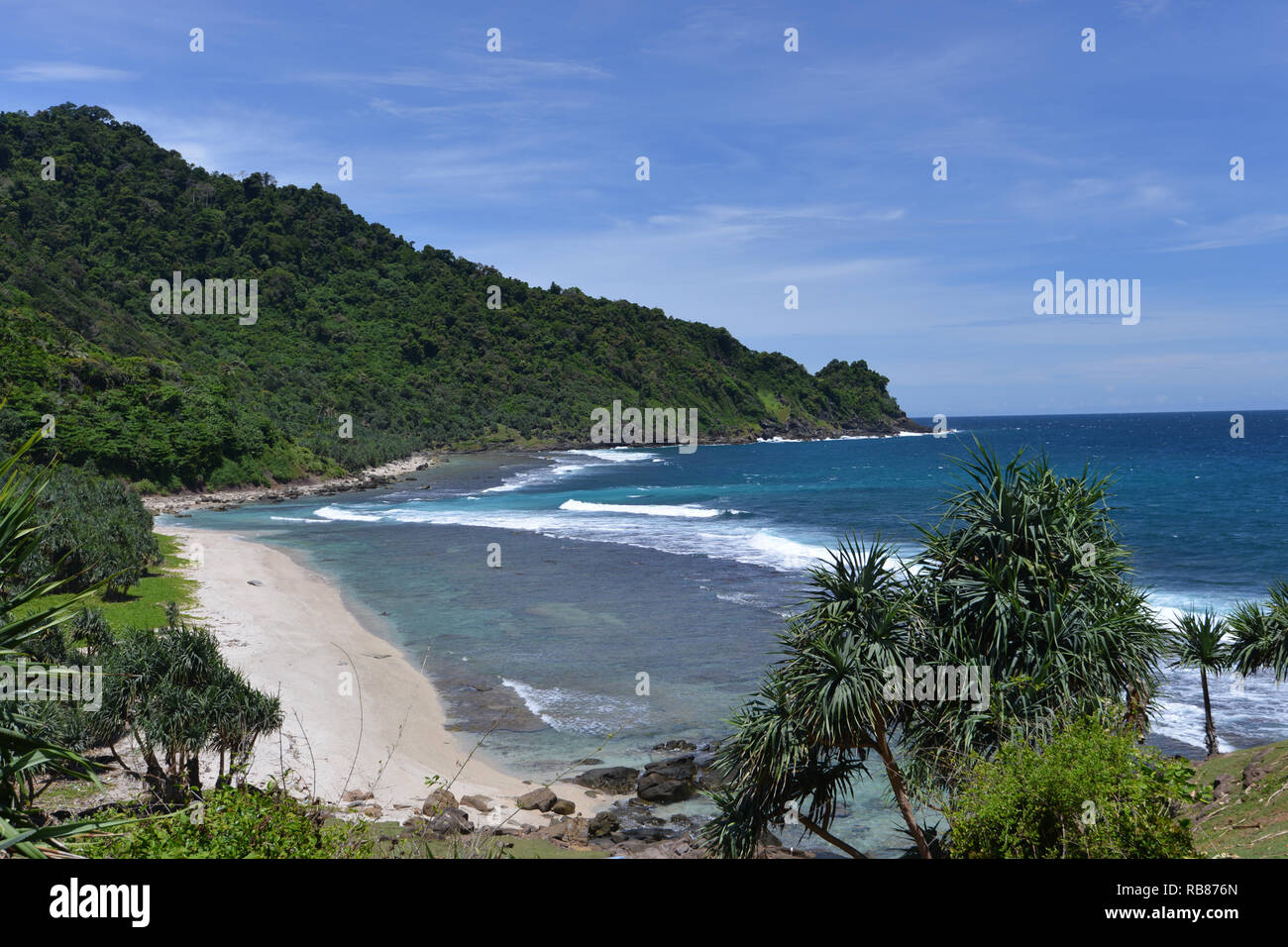 The pristine tropical forest covers the mountain range down to the ...