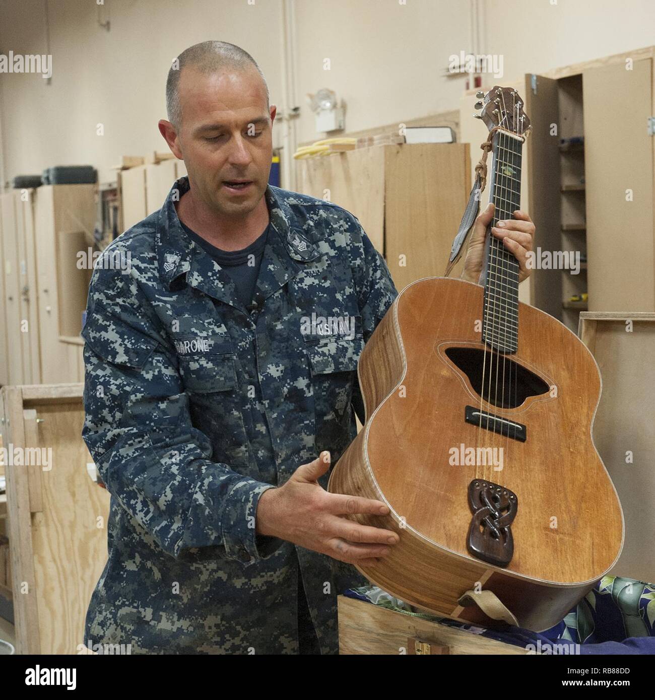 Petty Officer Frank Barone displays the guitar he built from scratch at ...