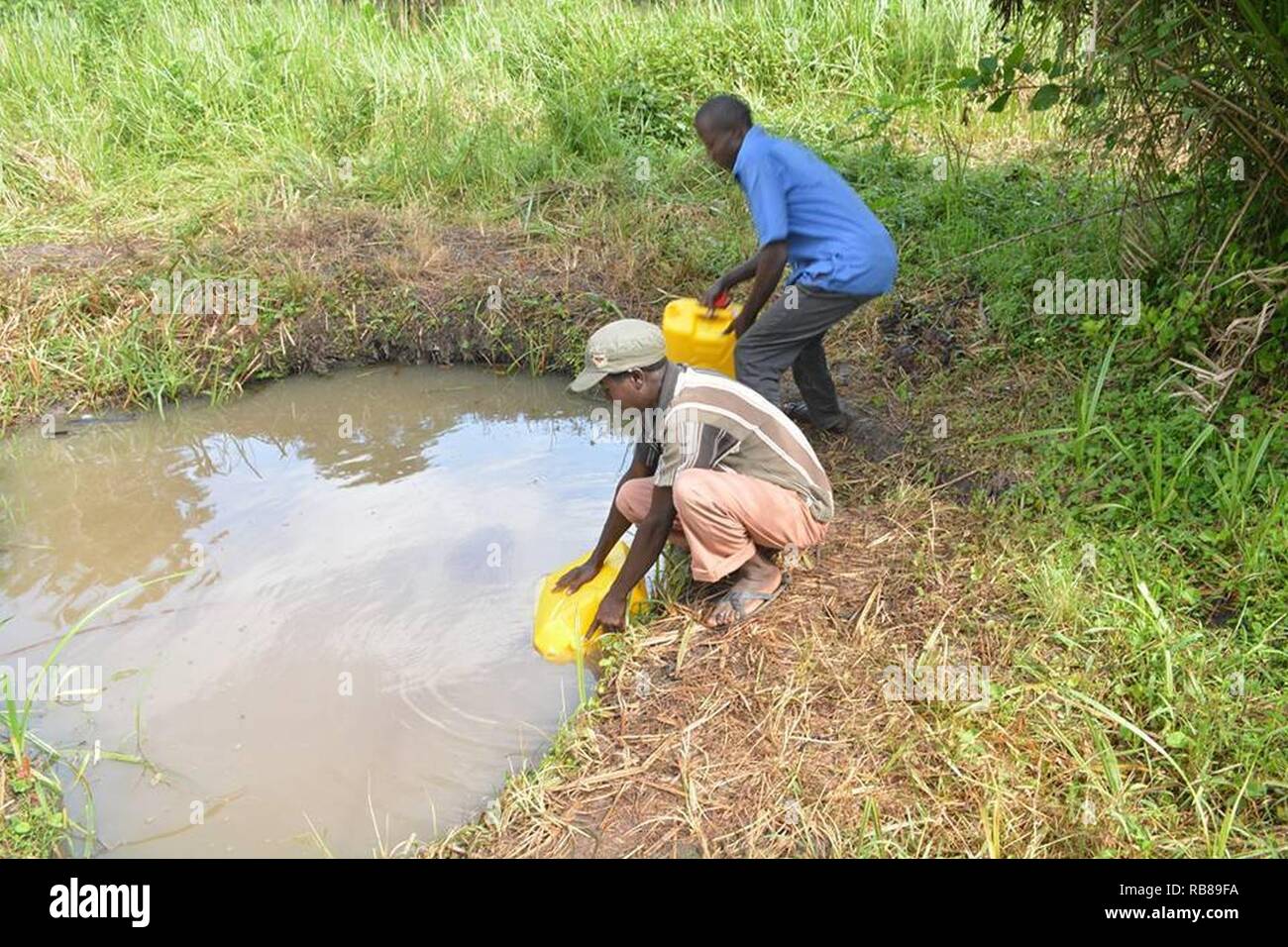 Villagers collect water from a local pond. The water, used for houshold ...