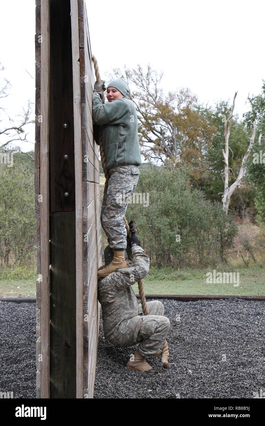 Spc. Victoria Lowery stands on her husband’s shoulder, Spc. Chad Lowery ...