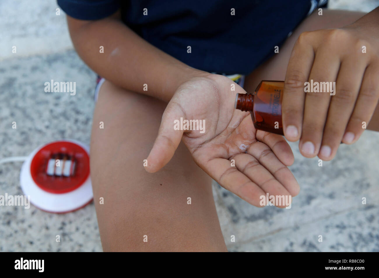 Boy pouring mosquito repellent in Salento, Italy Stock Photo - Alamy