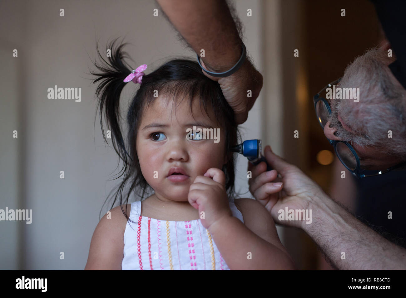 Nose and throat examination otoscope pediatrics hi-res stock ...