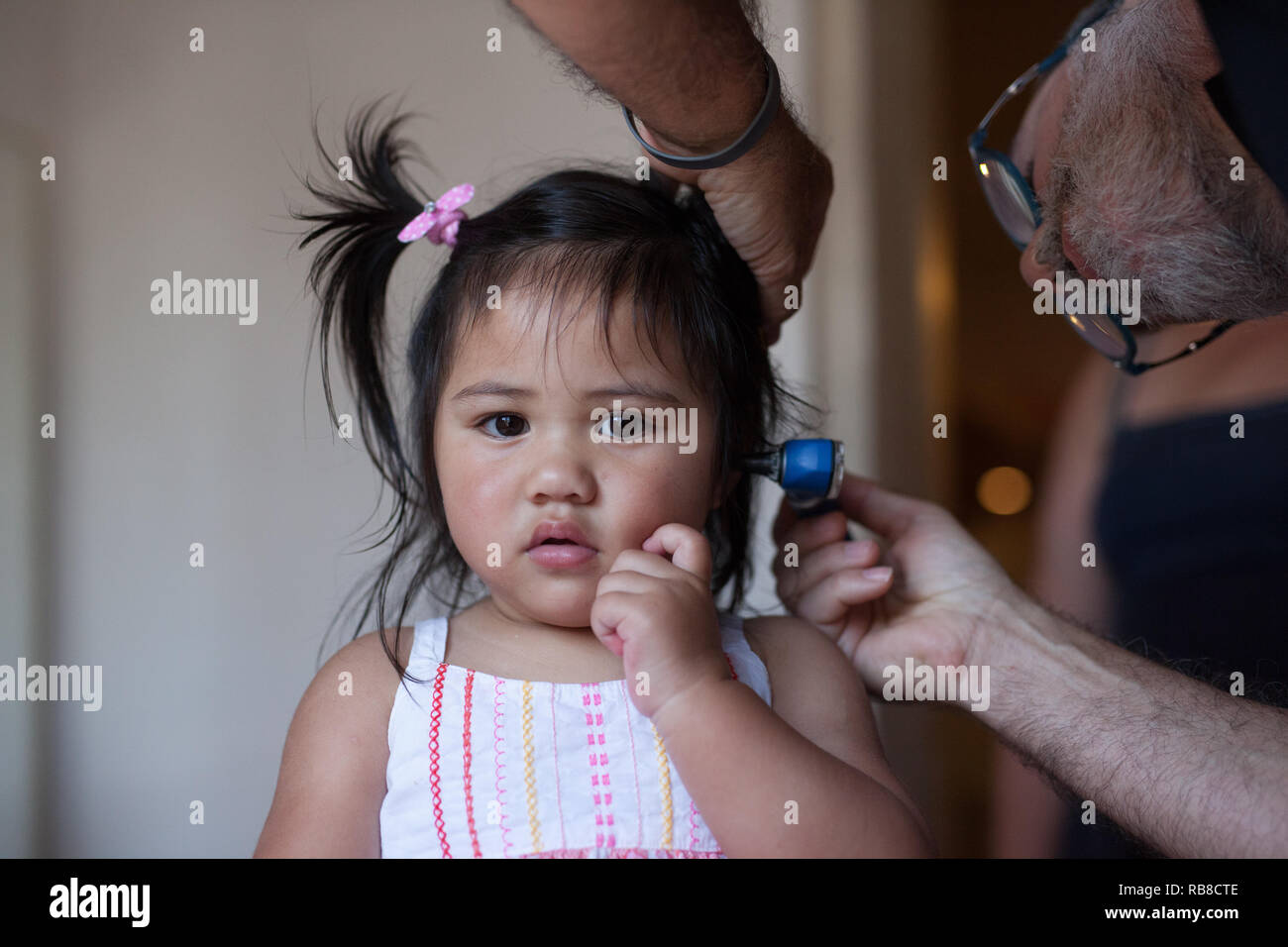 Nose and throat examination otoscope pediatrics hi-res stock ...