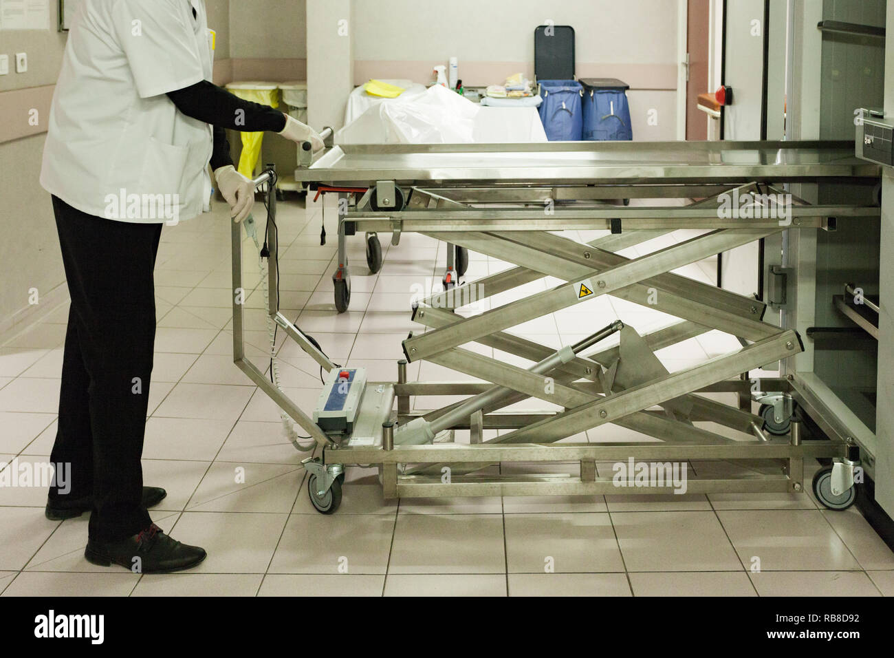 A dead body (corpse) is just arrived in the mortuary chamber in an ...