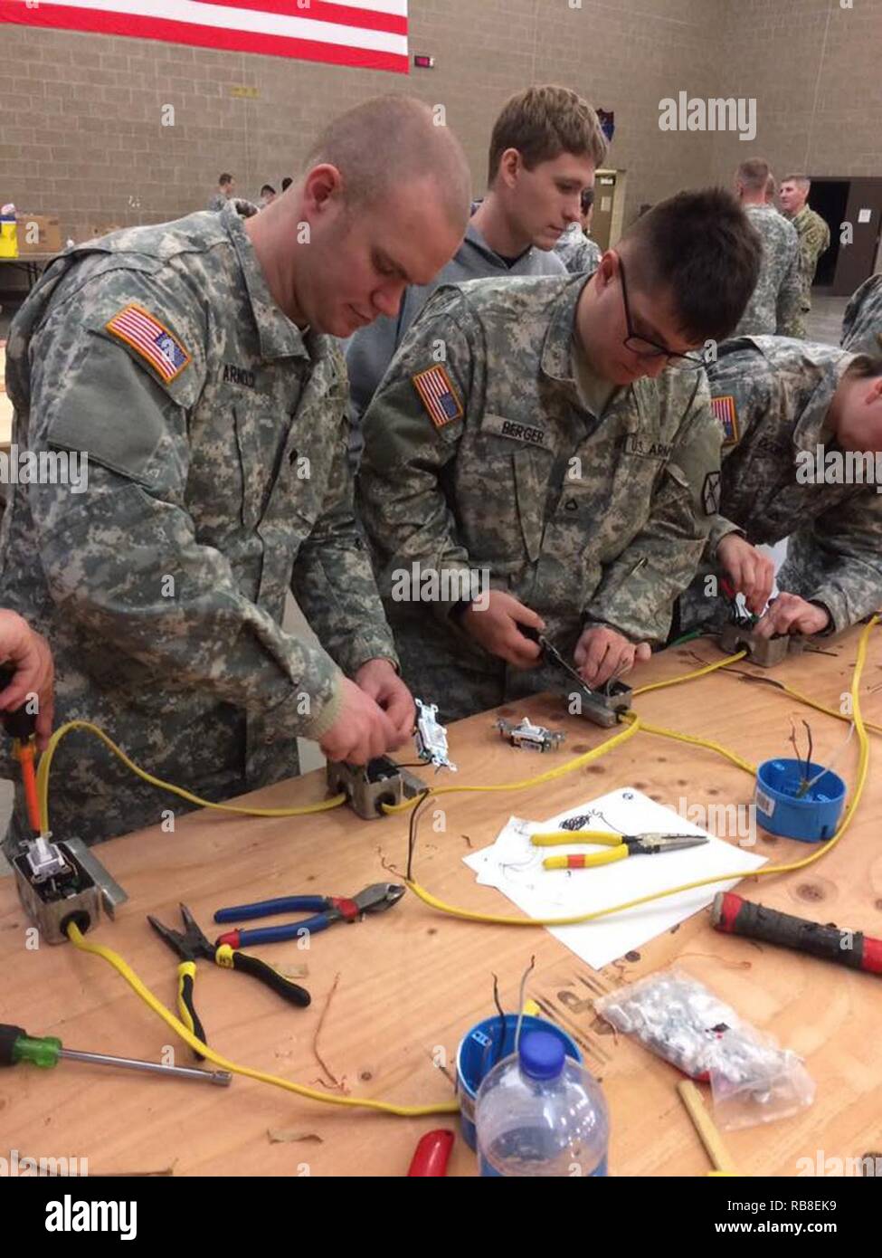 Spc. Johnathan A. Arnold, left, and Pfc. Dylan B. Berger wire a three ...