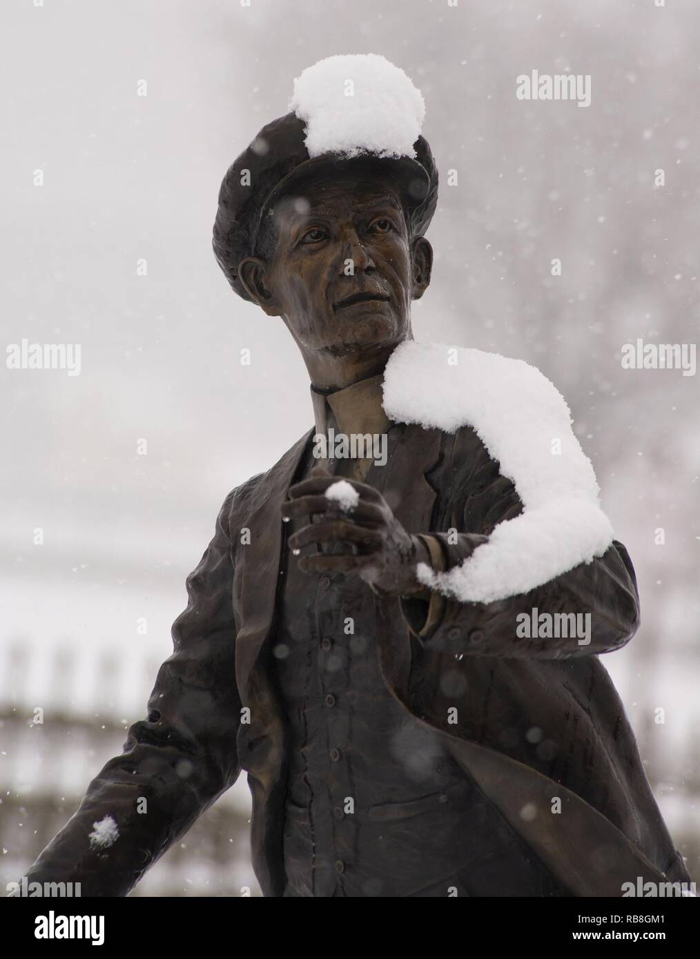 Snow settles on a statue of Wilbur Wright, part of a sculpture of the ...