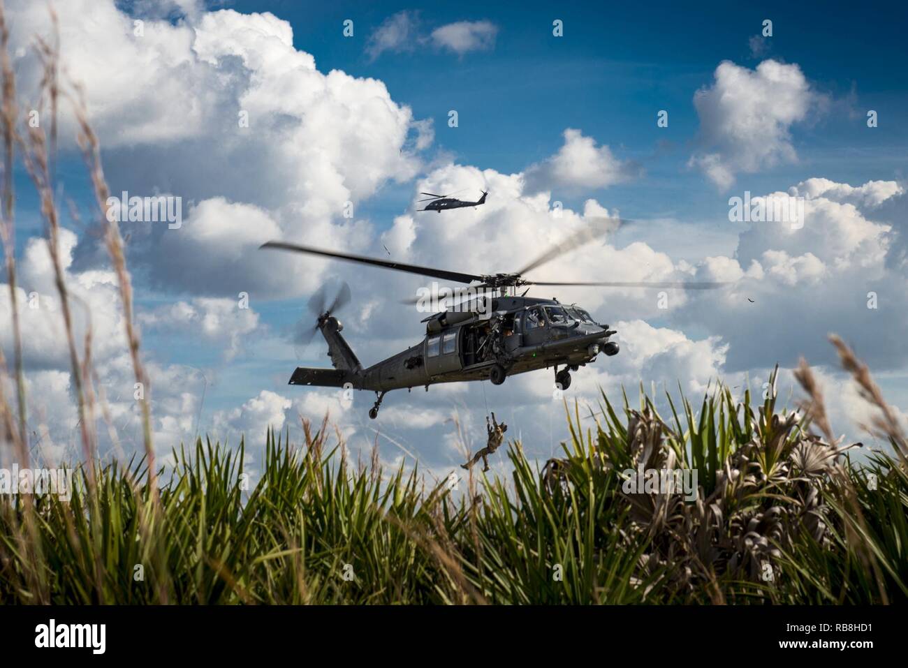 A pararescueman from the 38th Rescue Squadron rides a hoist back into a 41st RQS HH-60G Pave ...