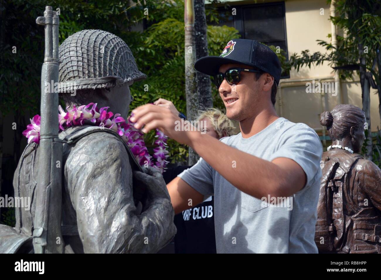 Koa Rothman places a lei over a statue at the 25th Infantry Division ...