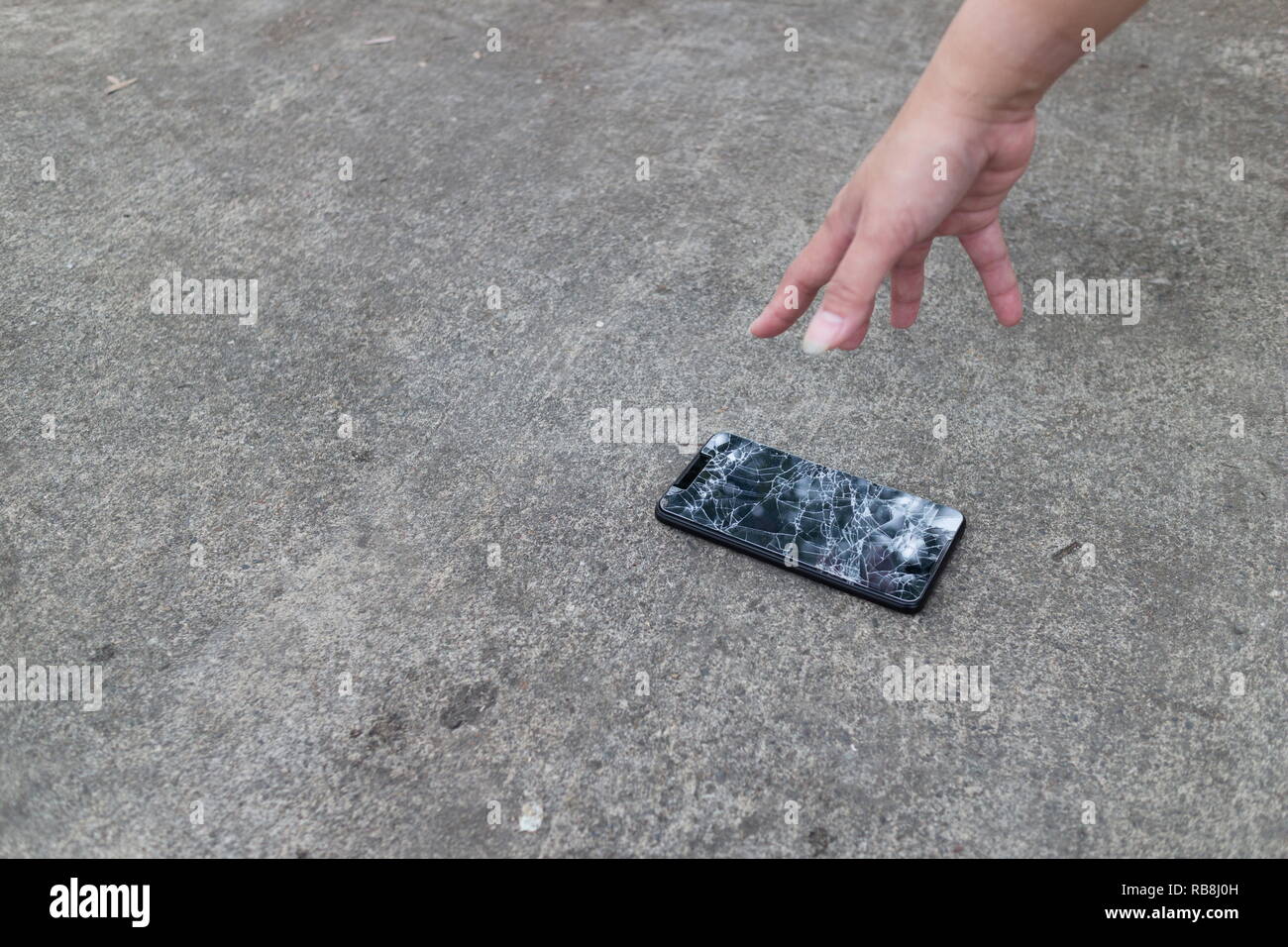 Smartphone fall out of hand and fall to the cement floor and the touch ...