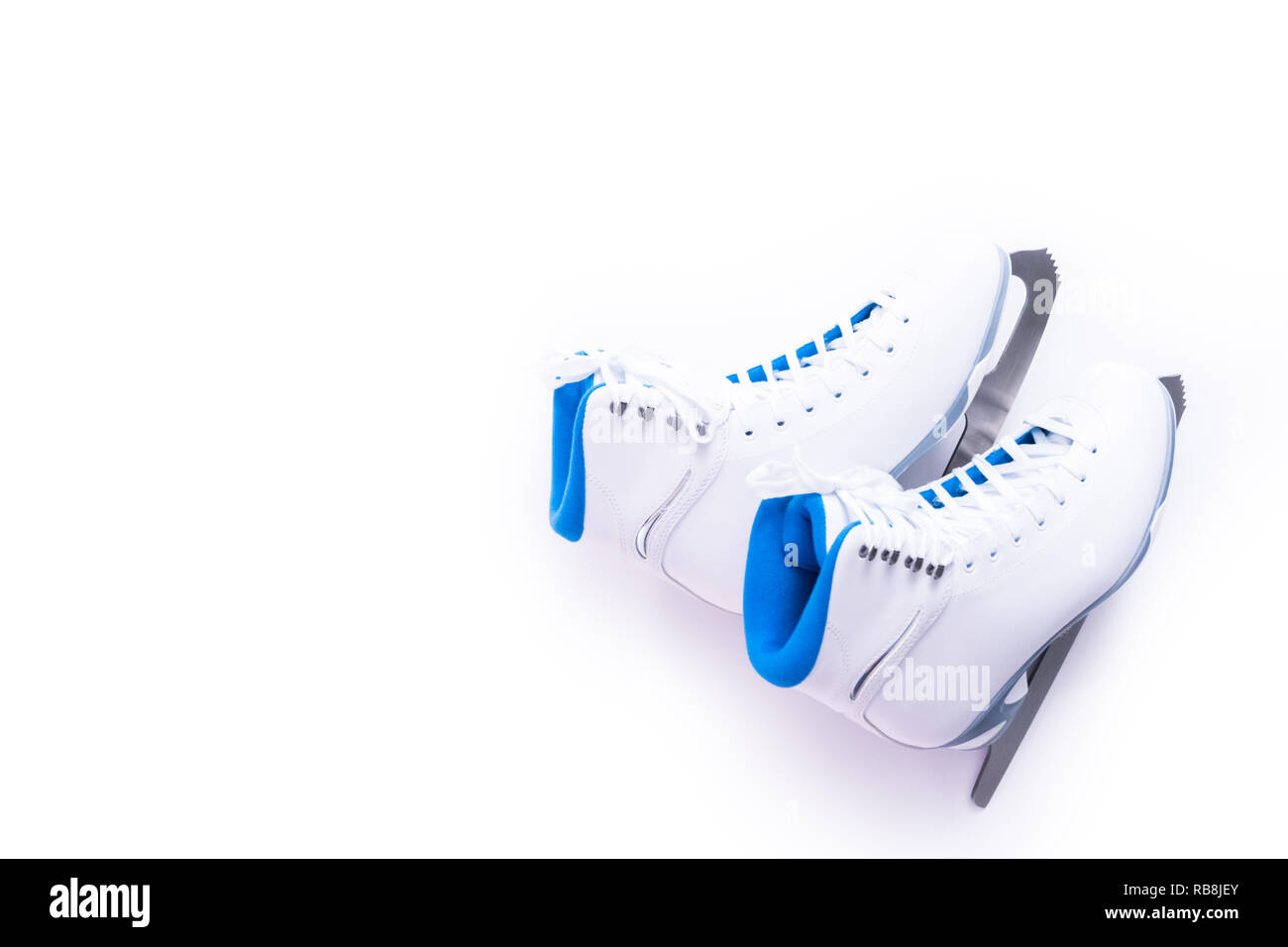 Flat lay. New white figure skates on a white background Stock Photo - Alamy