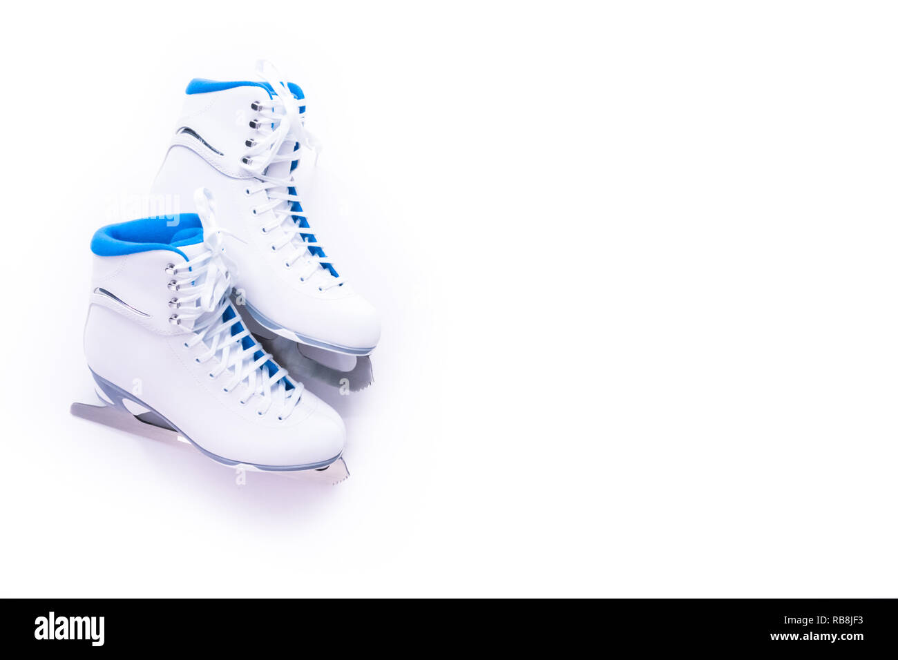 Flat lay. New white figure skates on a white background Stock Photo - Alamy