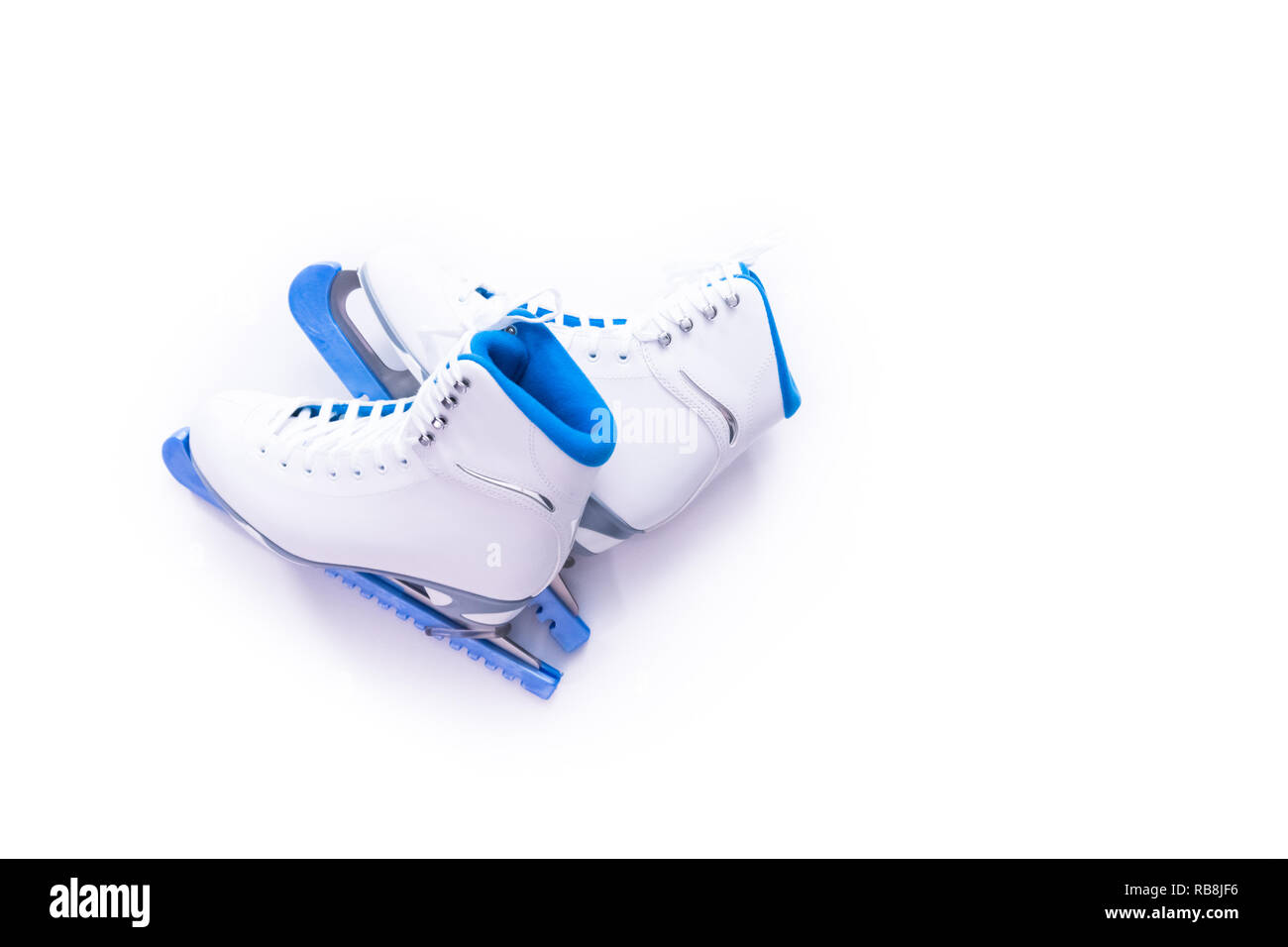 Flat lay. New white figure skates on a white background Stock Photo - Alamy