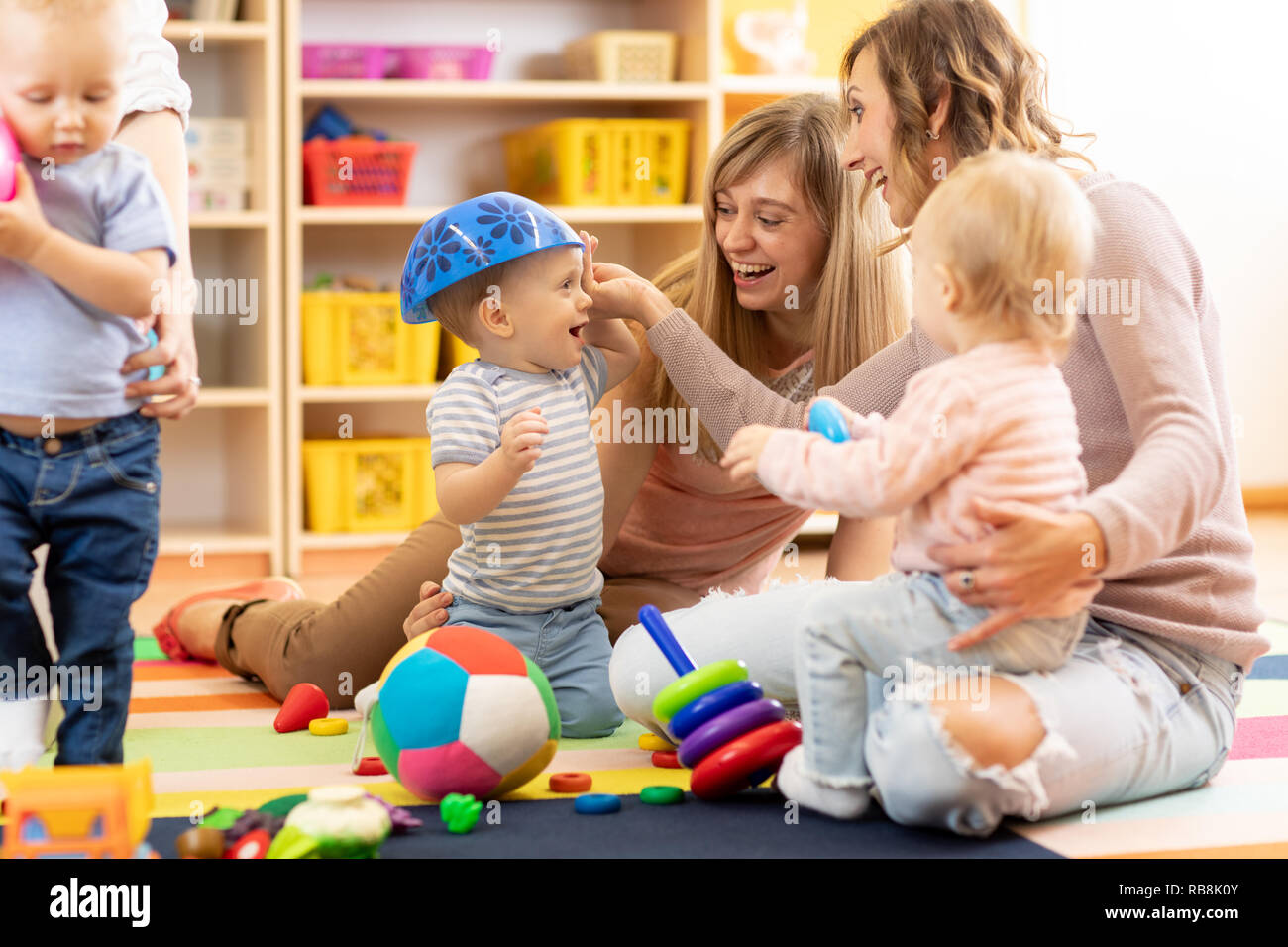 Group of young moms with their babies at playgroup Stock Photo - Alamy