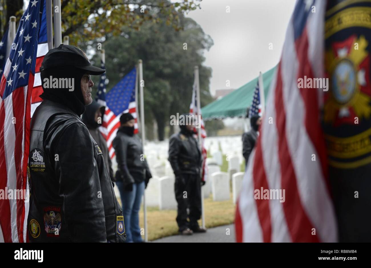 Members of the Virginia Patriot Guard hold the American Flag during a ...