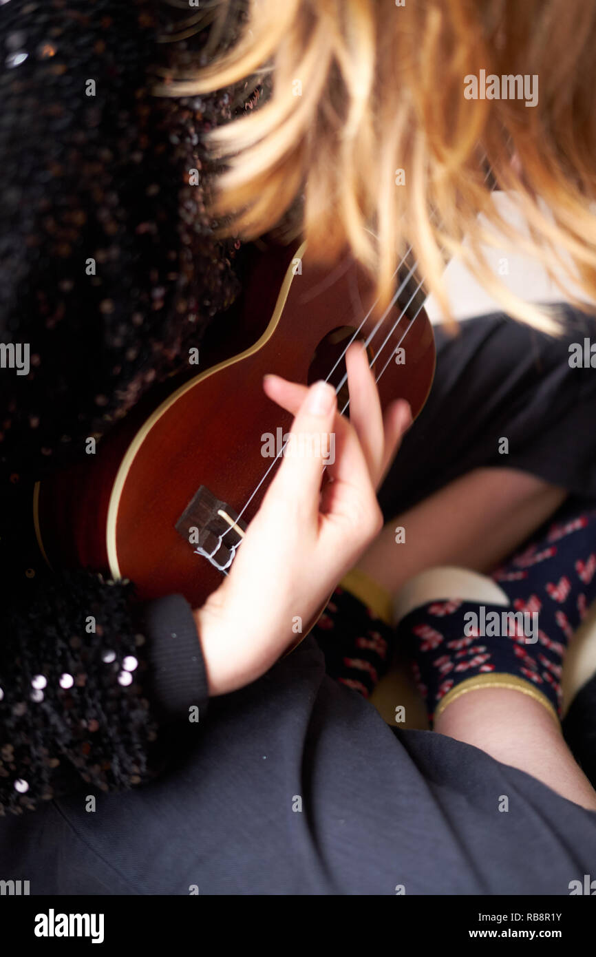 Woman playing a ukulele hi-res stock photography and images - Alamy