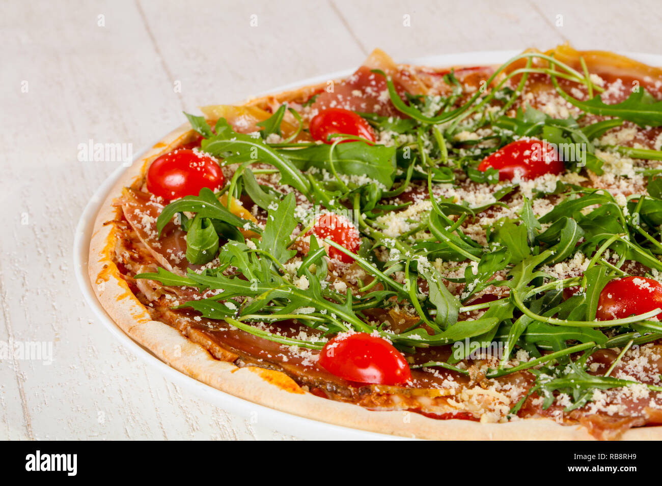 Pizza with hamon and ruccola Stock Photo - Alamy