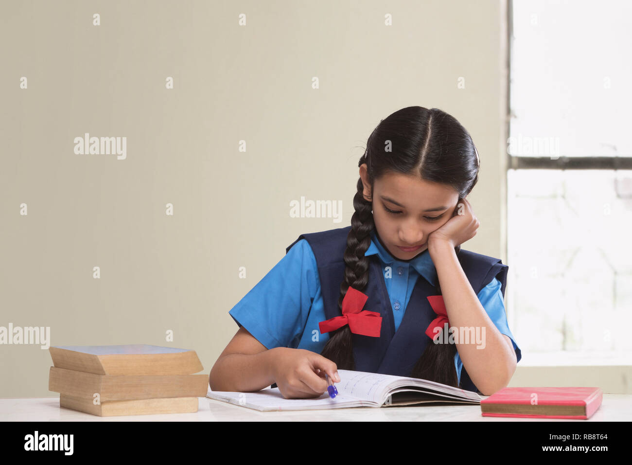 Rural girl sitting in classroom reading book Stock Photo - Alamy
