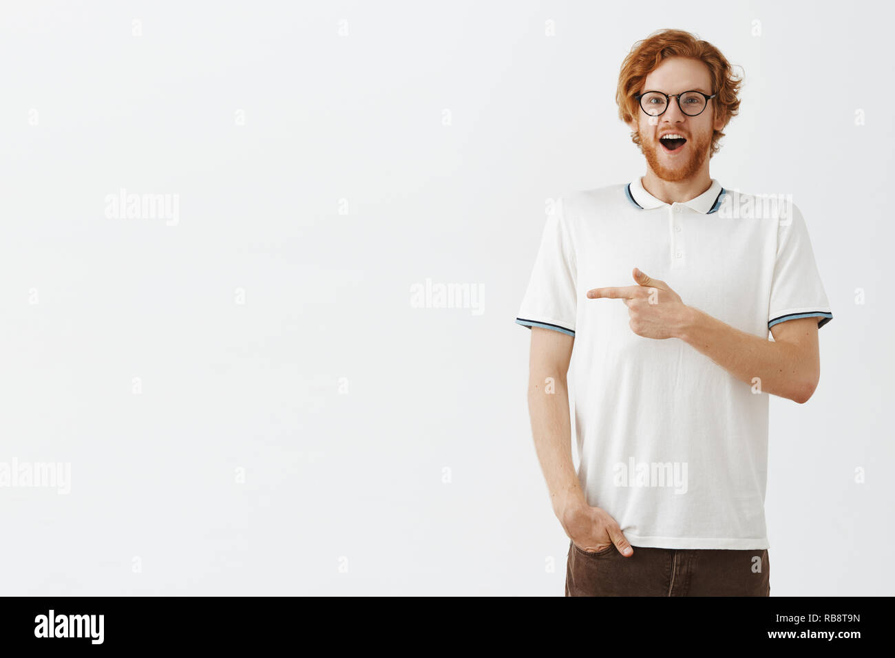 Indoor shot o fimpressed speechless funny ginger man with long beard ...