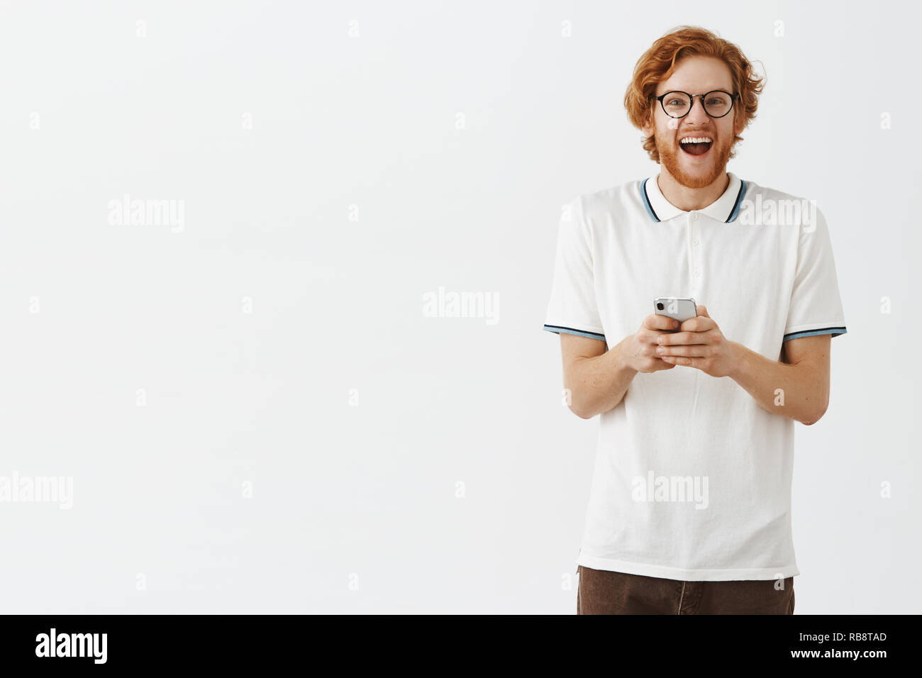 Indoor shot of excited and enthusiastic funny redhead european guy in ...