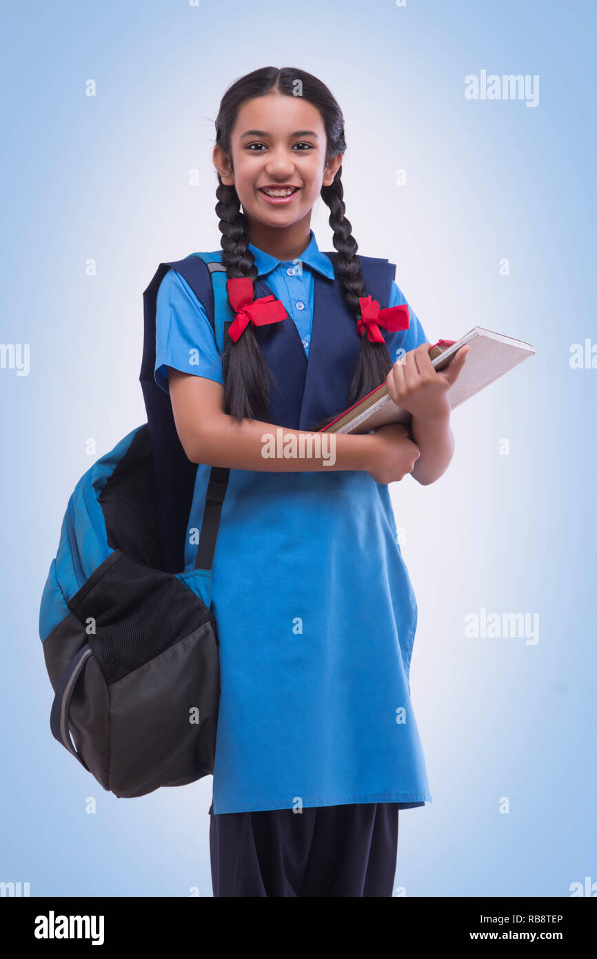 Girl writing notes in classroom Stock Photo - Alamy