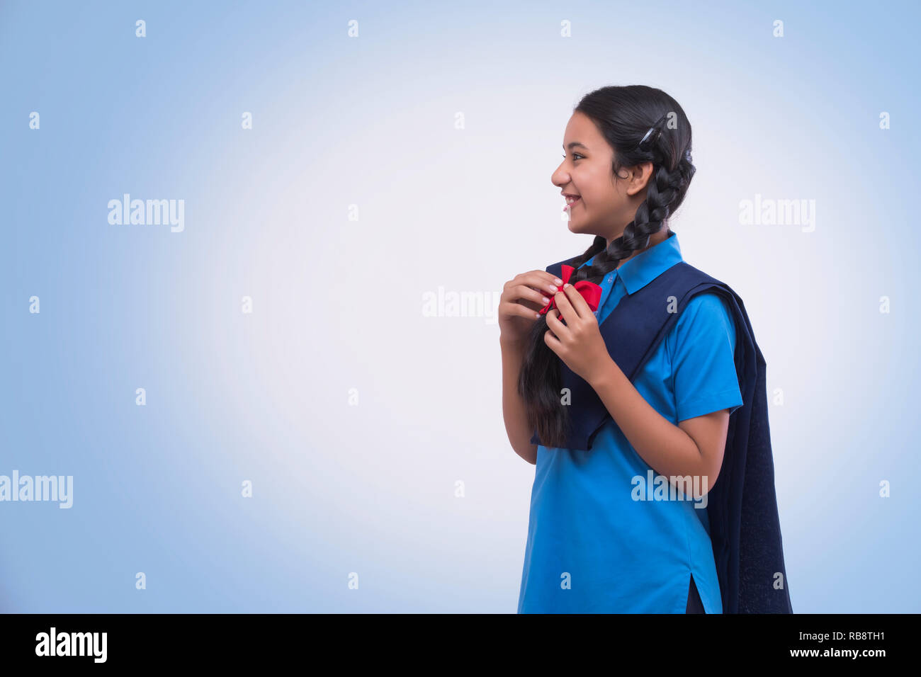 Side view of rural school girl in uniform Stock Photo - Alamy